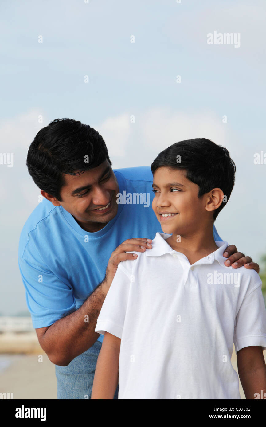 Father looking at son and smiling Stock Photo - Alamy