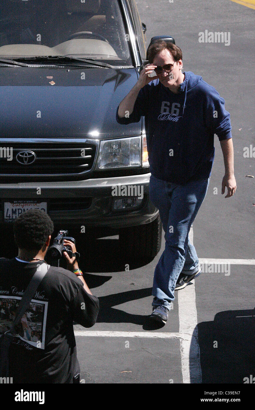 Quentin Tarantino going back to his parked Ford Mustang after having ...