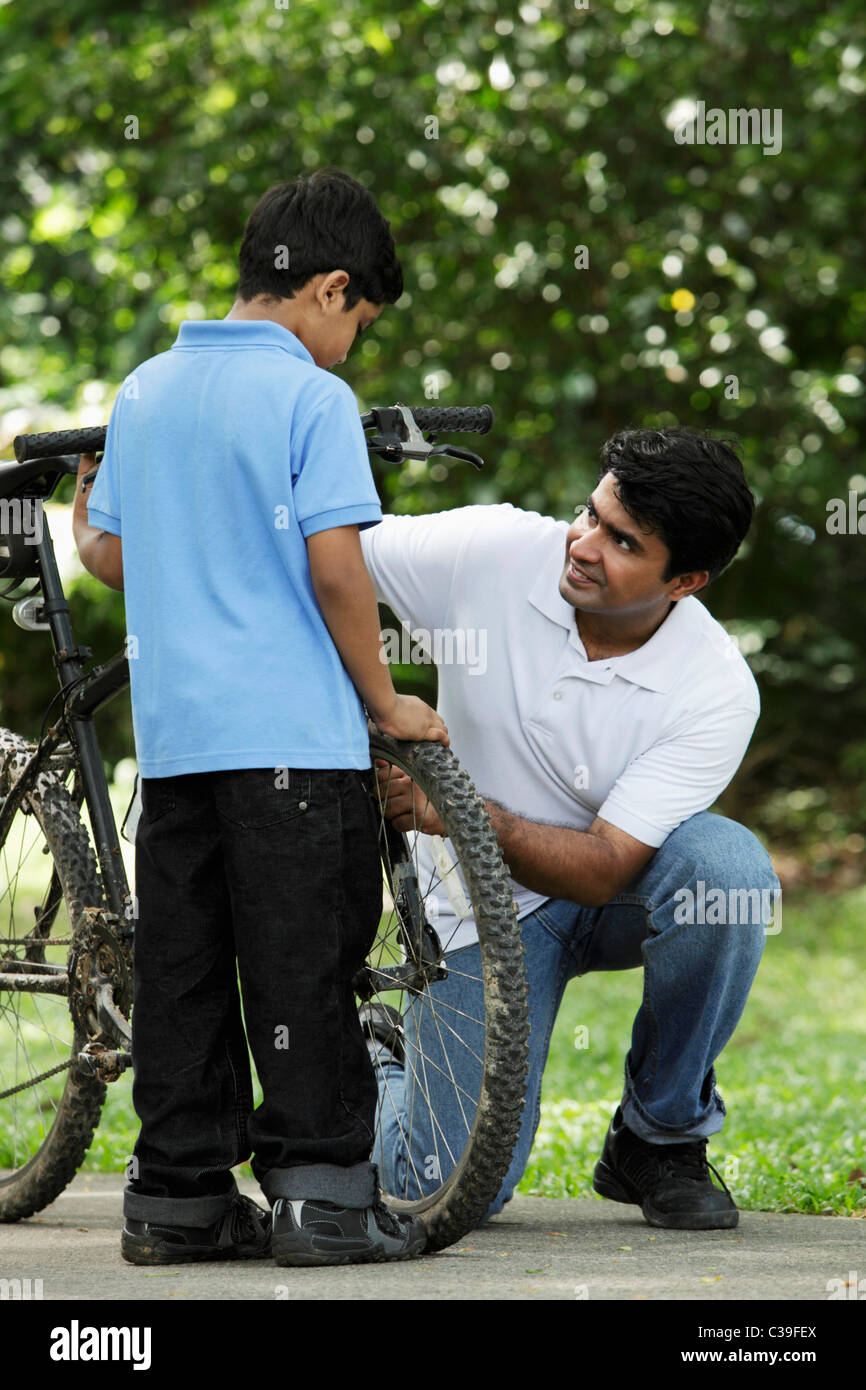 Father and son fixing bike together Stock Photo - Alamy
