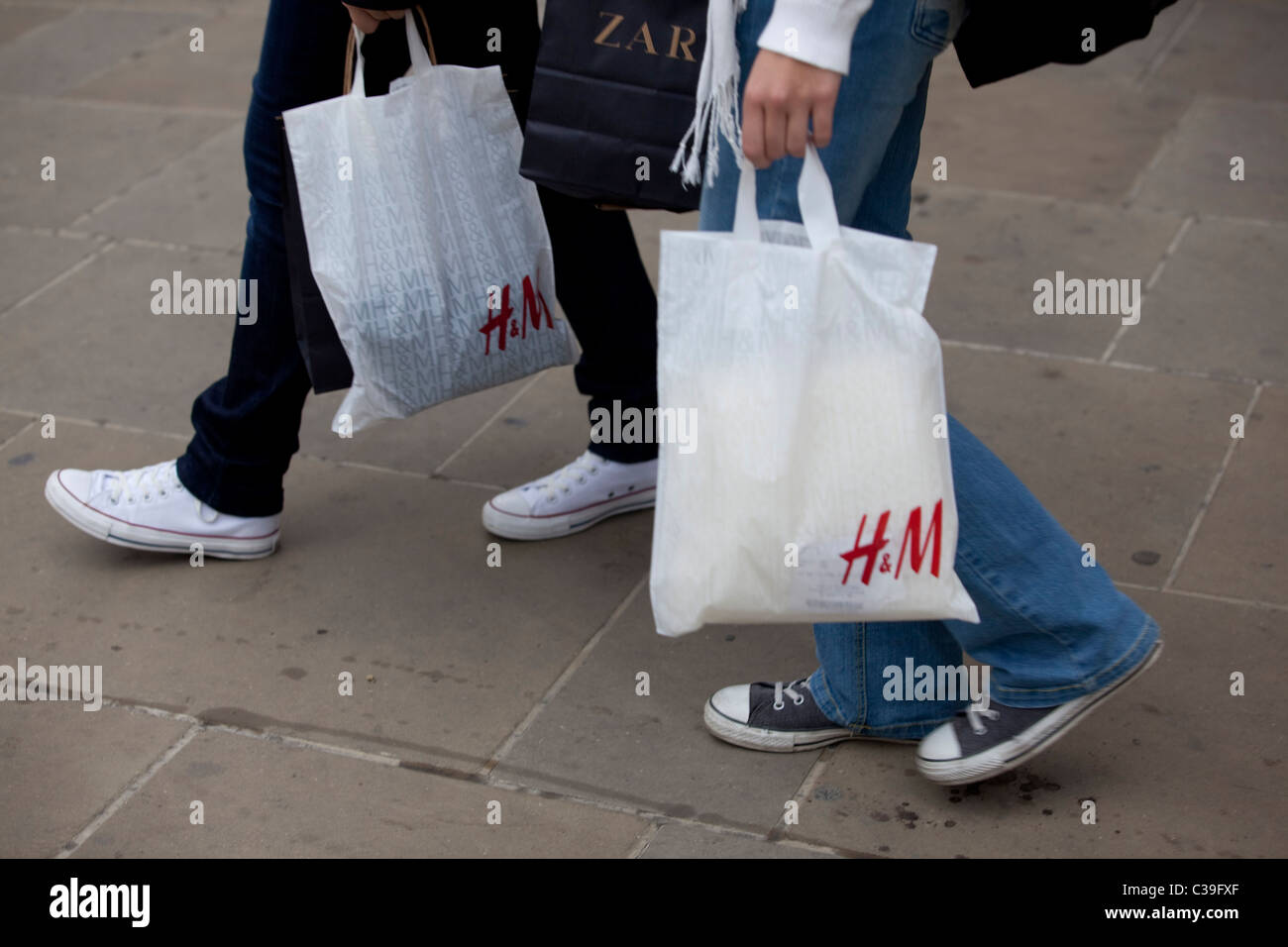 Two H&M customers leaving a store with their purchases Stock Photo - Alamy