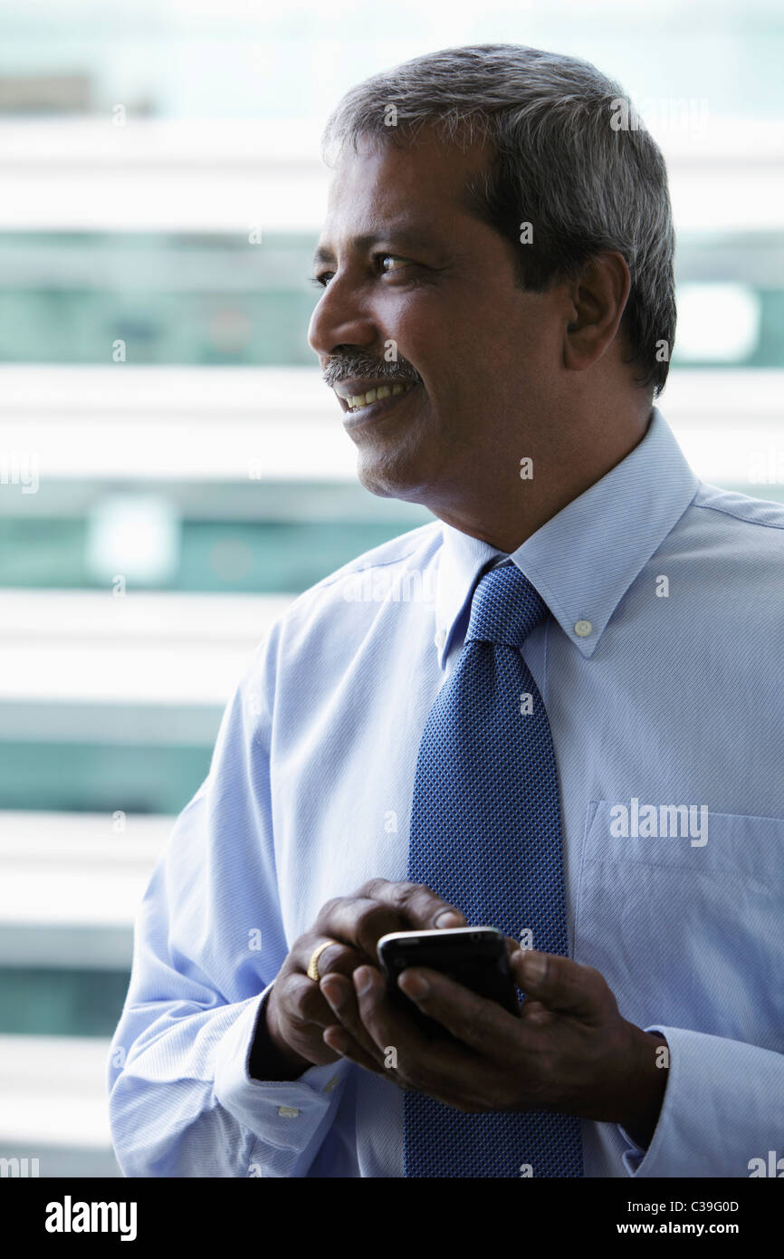 Profile of Indian man texting on phone Stock Photo - Alamy