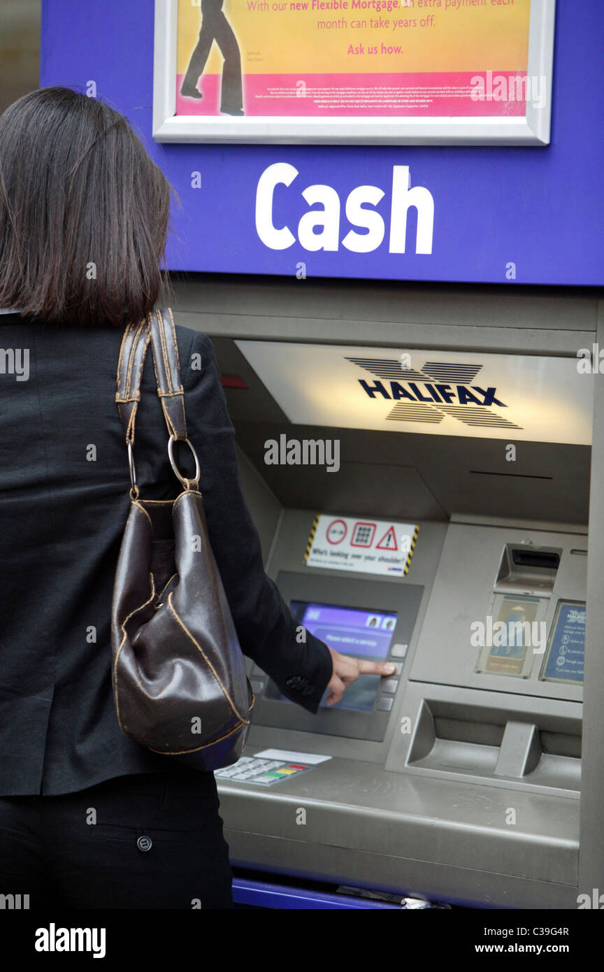 Picture shows: A woman using a Halifax cash machine on Oxford Street ...