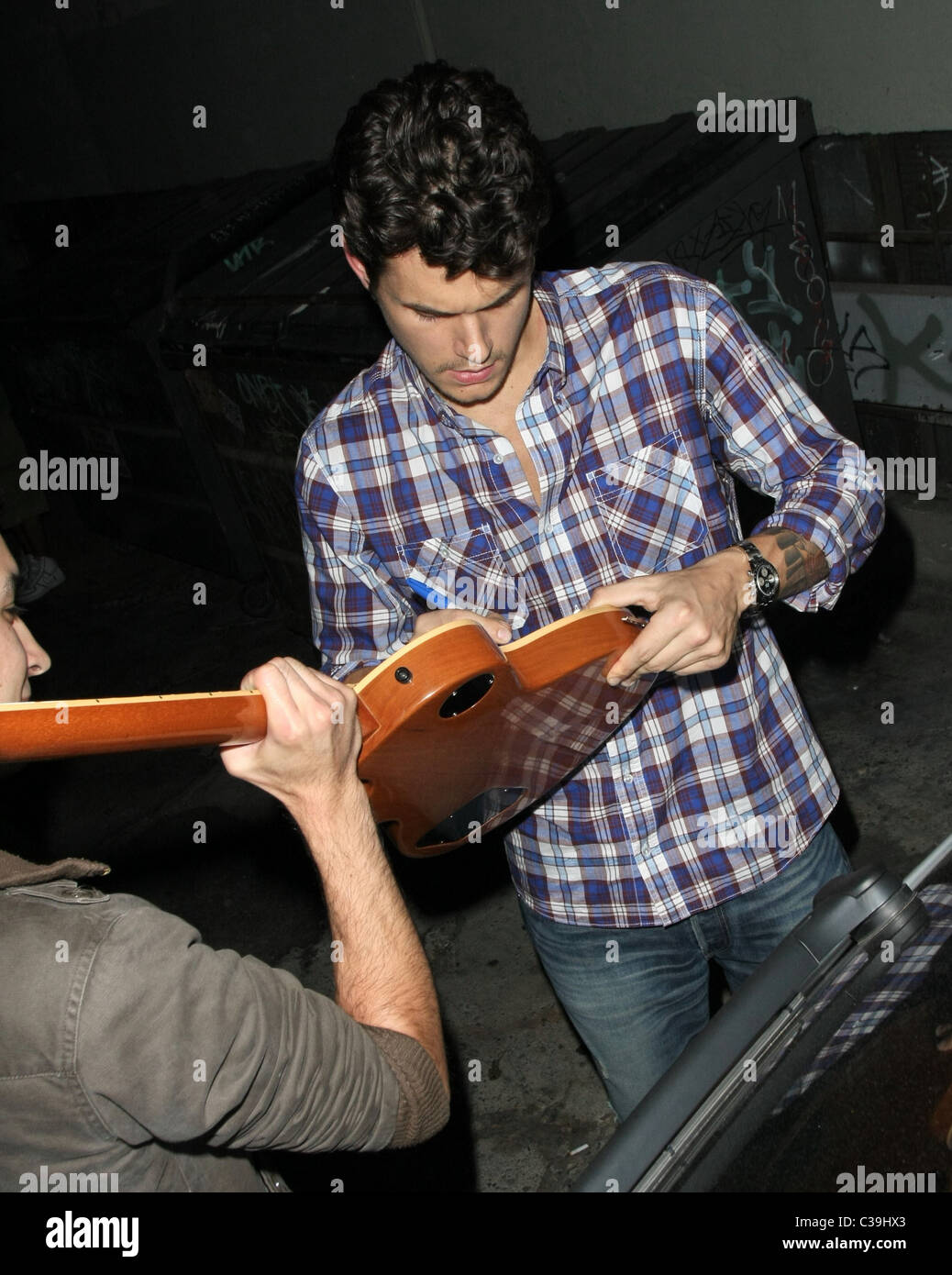 John Mayer signs and autograph on a guitar leaving the Hotel Cafe Los ...