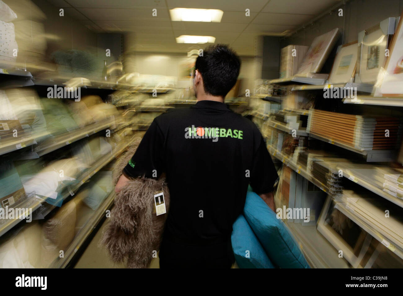 A Homebase employee working in the soft furnishings department Stock ...