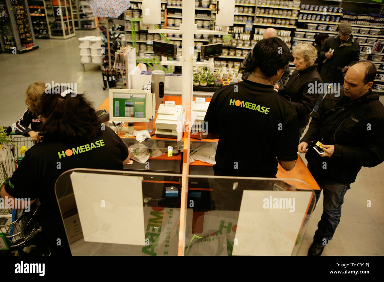 Employees working a till points in a Homebase store Stock Photo - Alamy