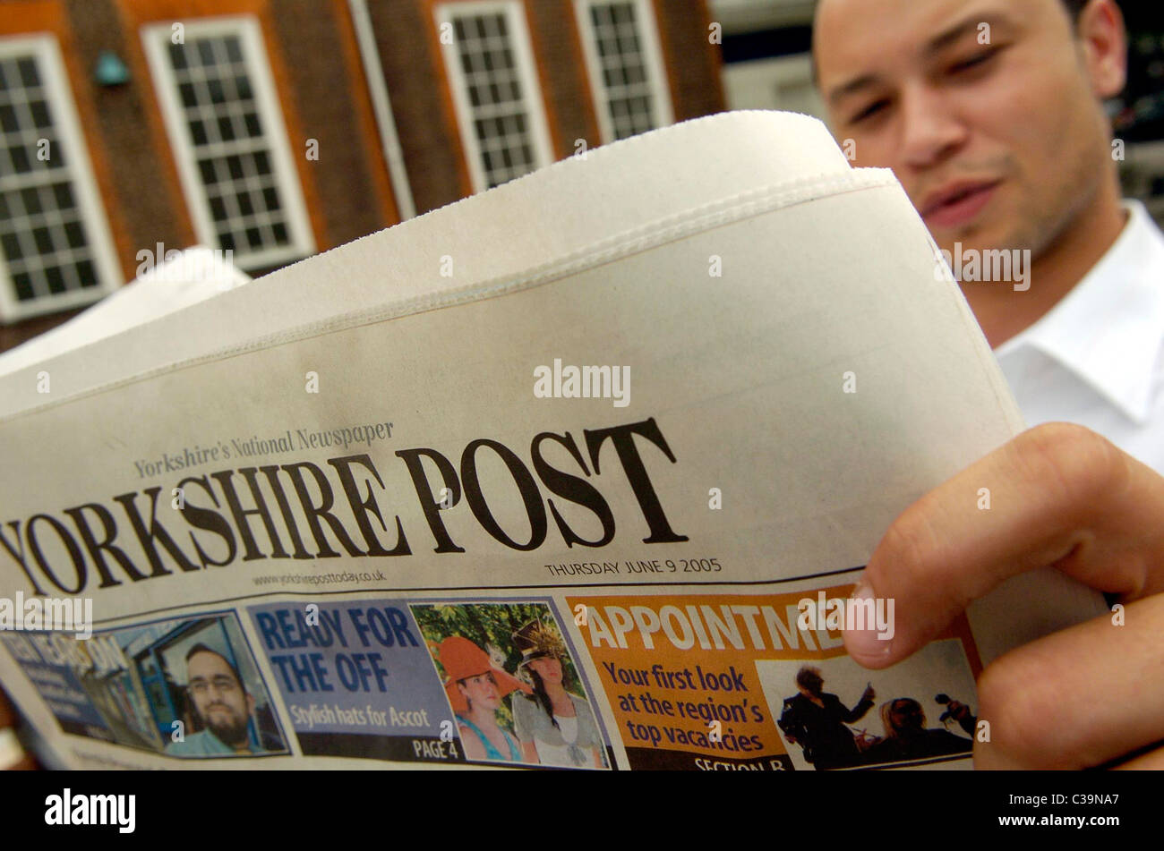a man reading a copy of the Yorkshire Post newspaper, a Johnston Press ...