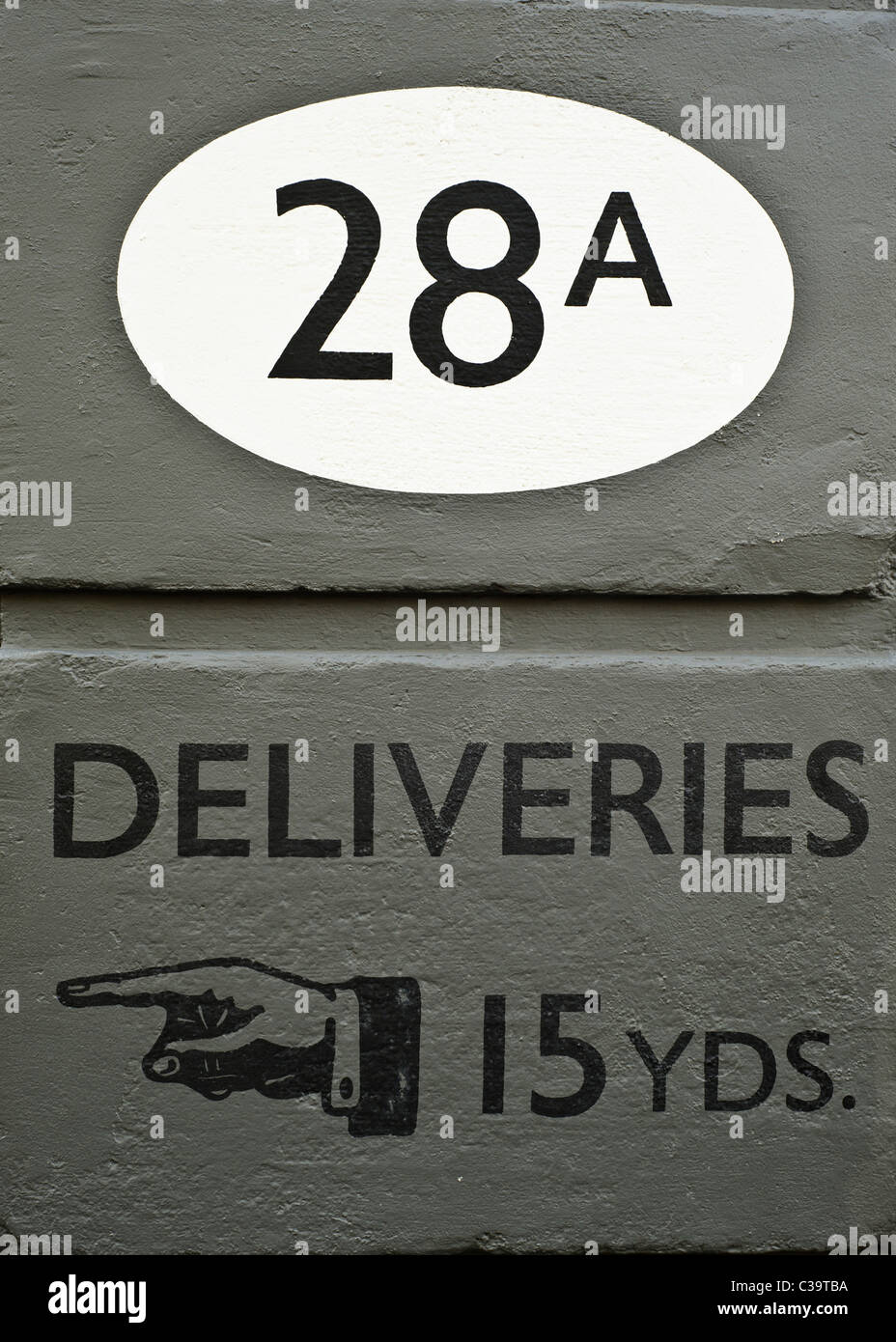 Number 28a painted on a grey wall with a finger pointing for deliveries ...