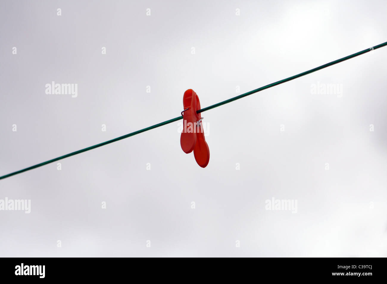 Single red peg on clothes line Stock Photo - Alamy