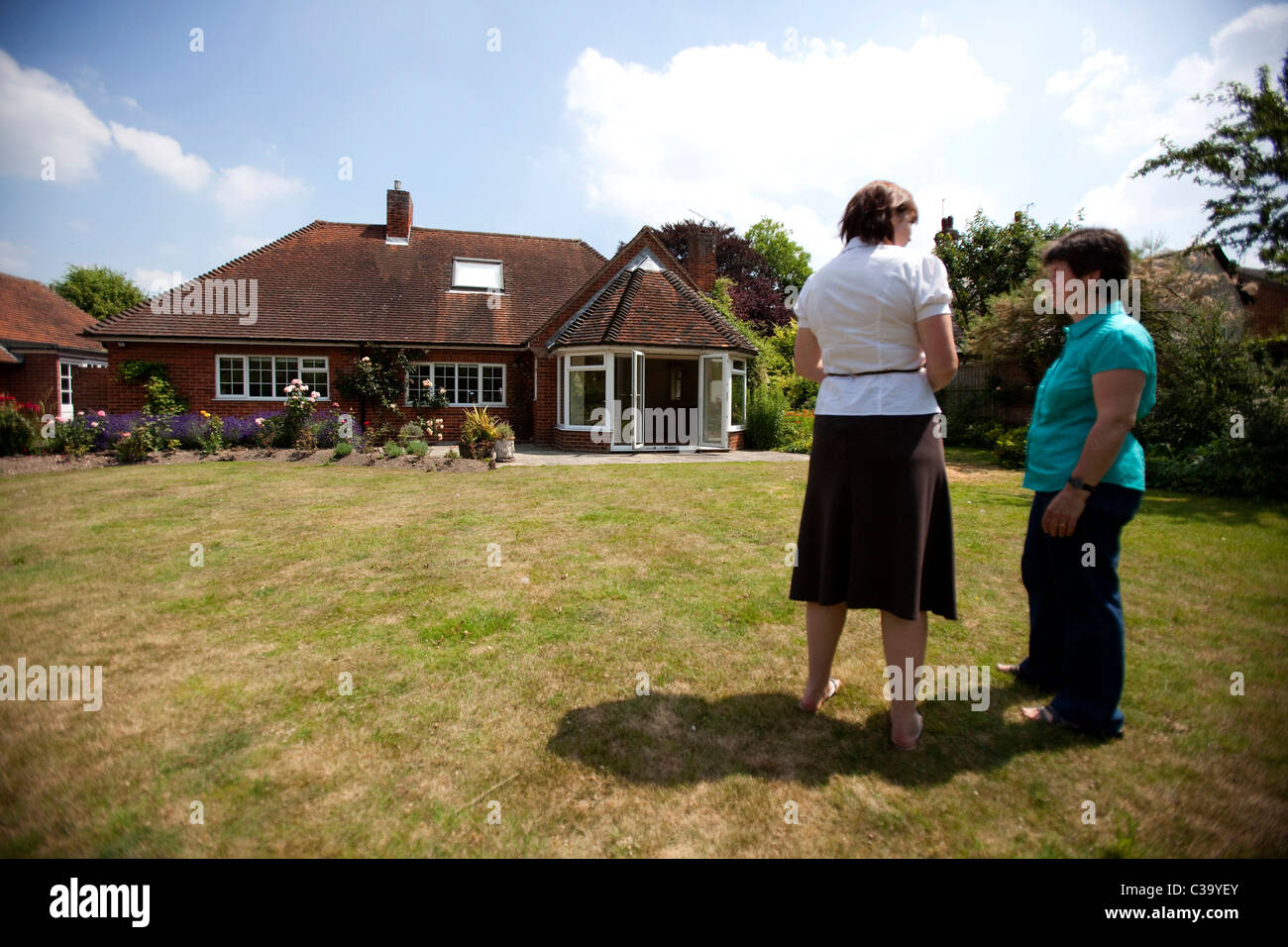 Estate agent giving a house viewing Stock Photo - Alamy