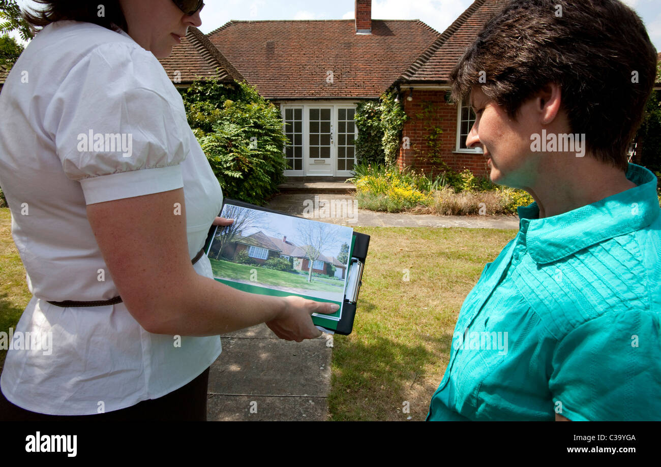 Estate agent giving house viewing Stock Photo - Alamy
