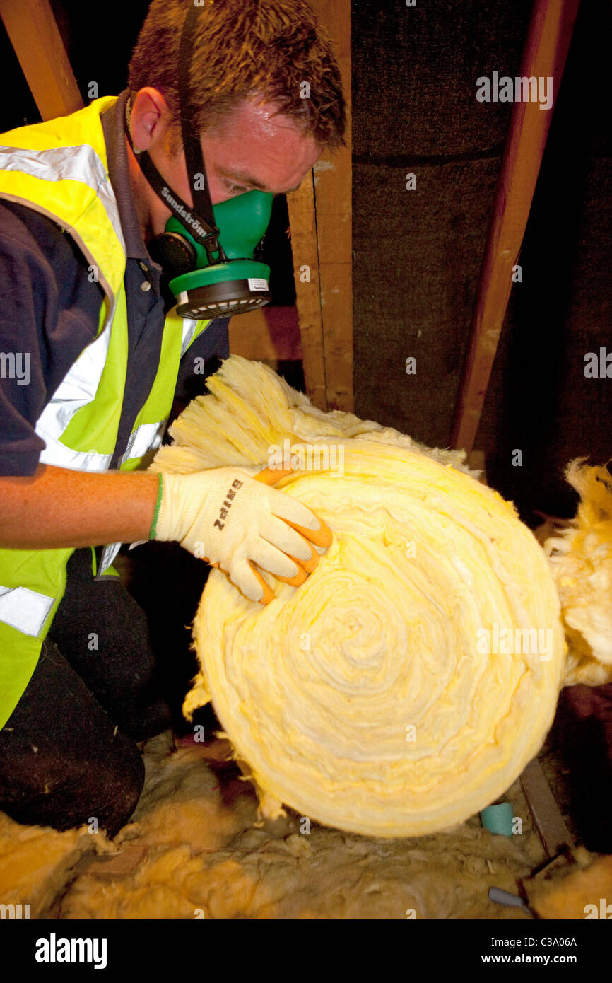 Illustrative image of loft insulation. A worker from Total Insulation ...