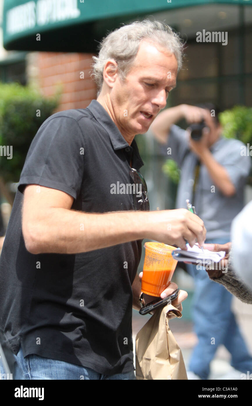 Michael Bolton carrying a bag of medication and drinking a smoothie ...