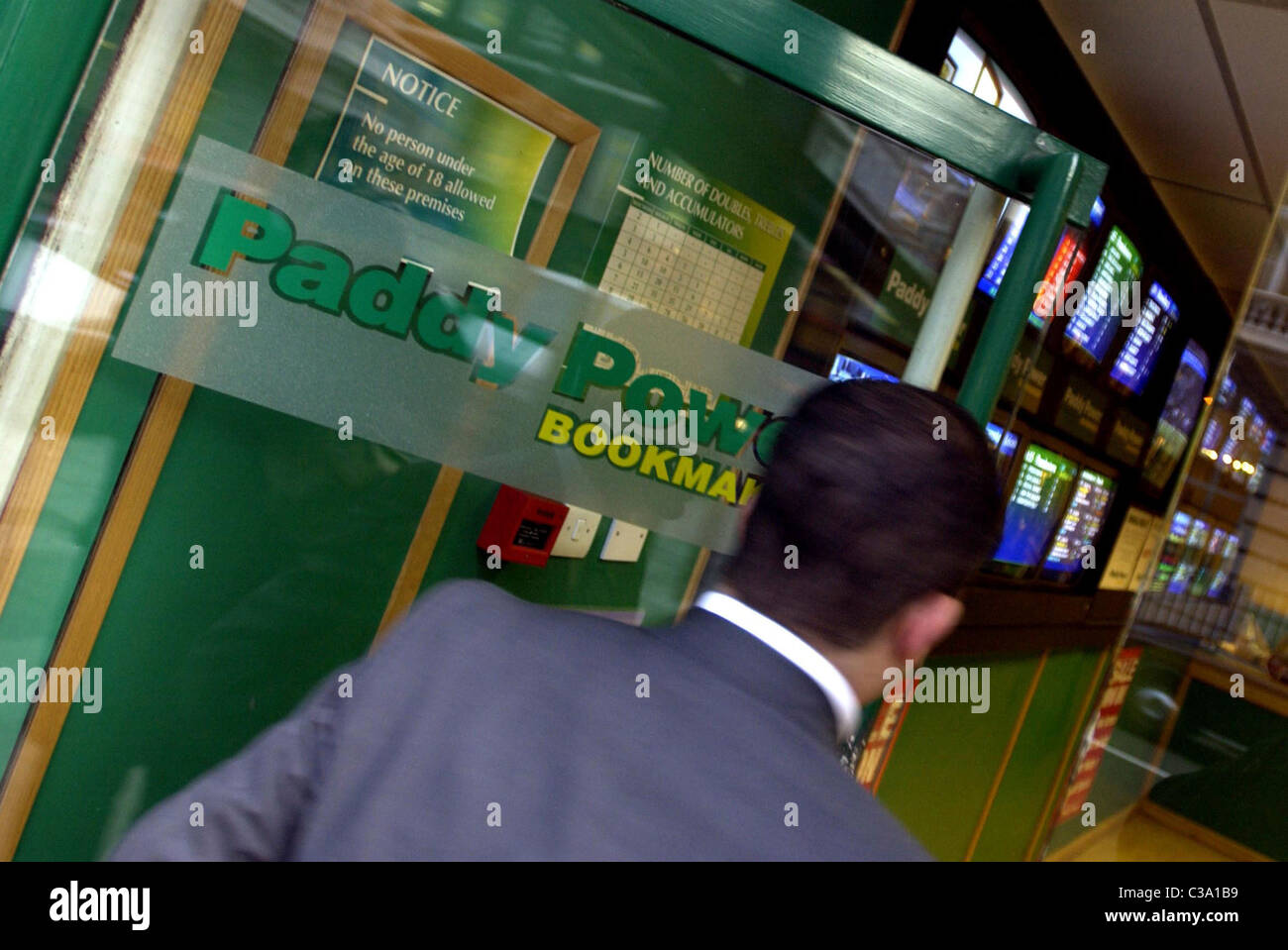 A man entering a Paddy Power bookmakers Stock Photo - Alamy