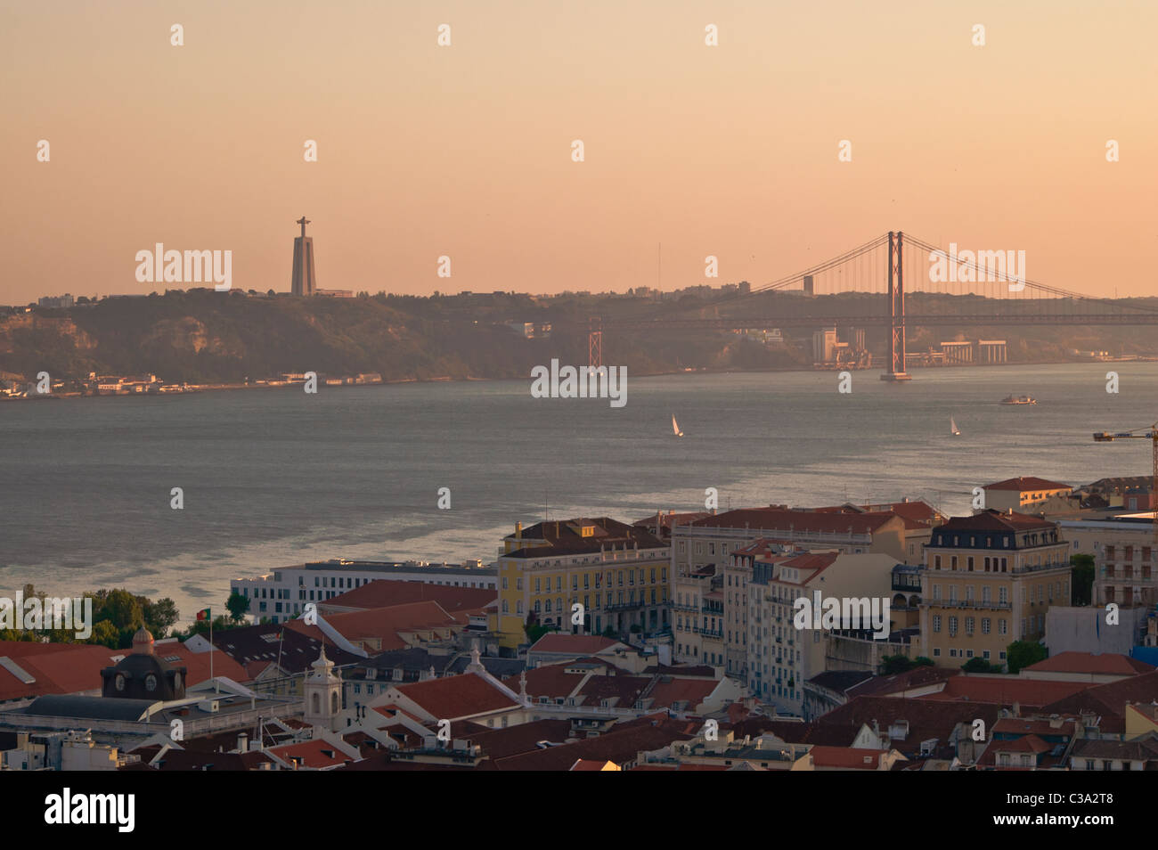 An evening view of Lisbon with river and bridge Stock Photo - Alamy