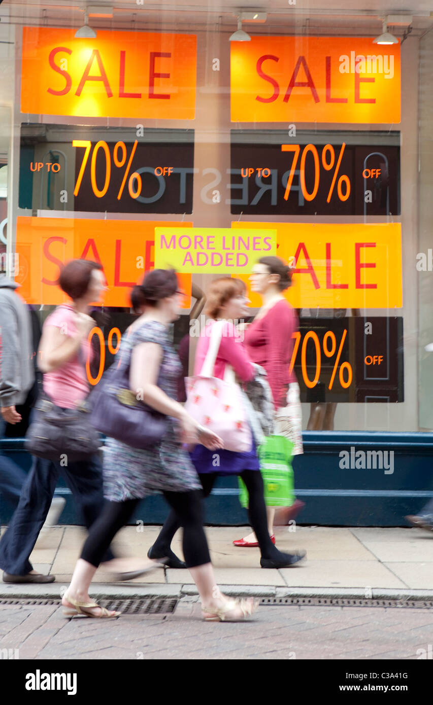 People walk past a sale sign Stock Photo - Alamy