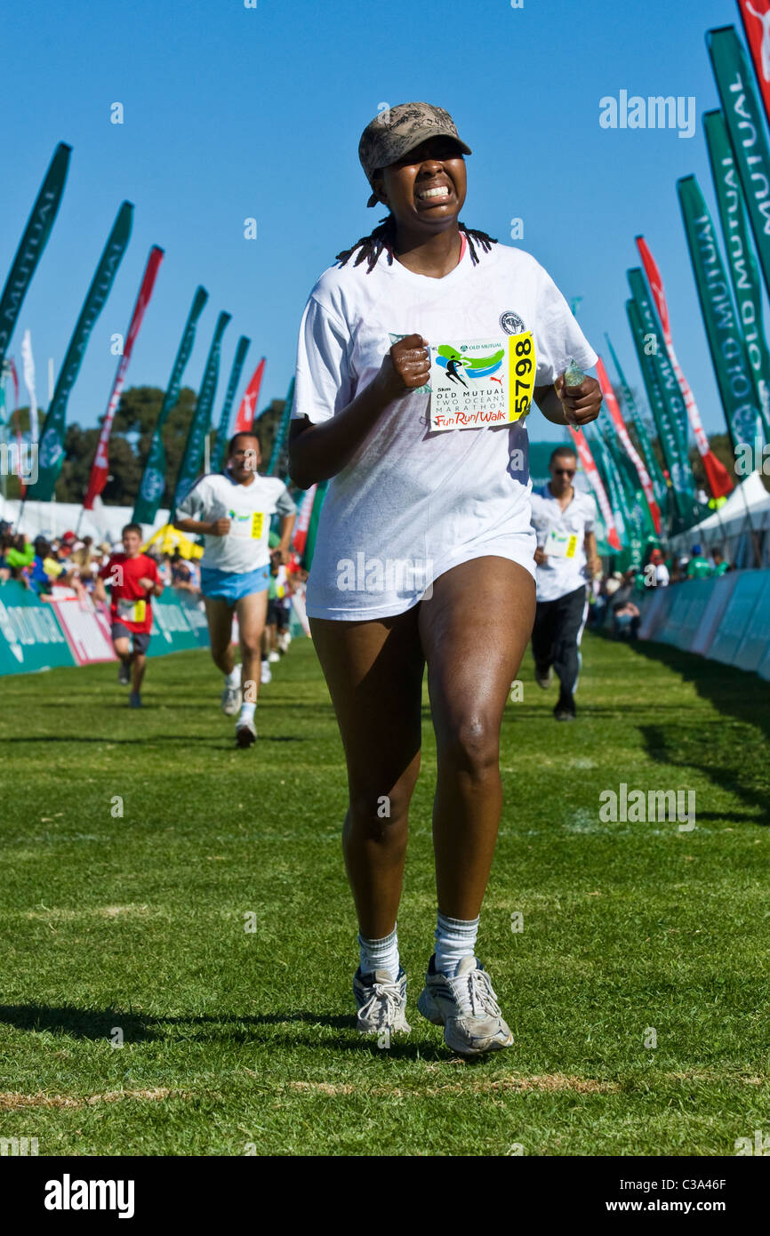 Female runner making an effort to finish the 5km Fun Run, Two Oceans ...