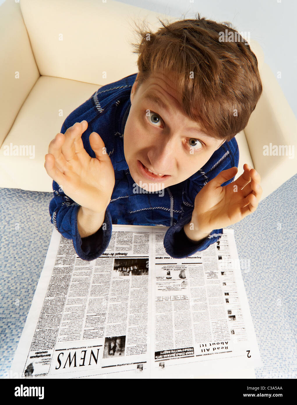 Man shocked by bad news as read from the newspaper Stock Photo - Alamy
