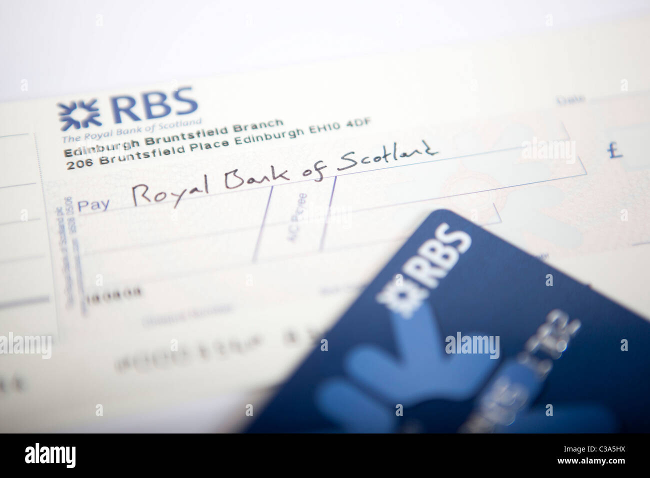 Illustrative image of an RBS cheque book and current account card Stock ...