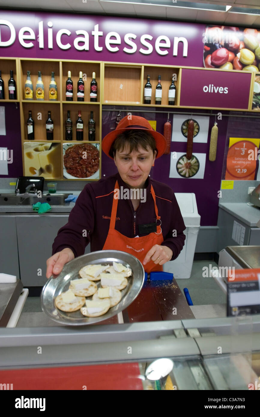 A member of staff serving a customer at the delicatessen counter Stock ...