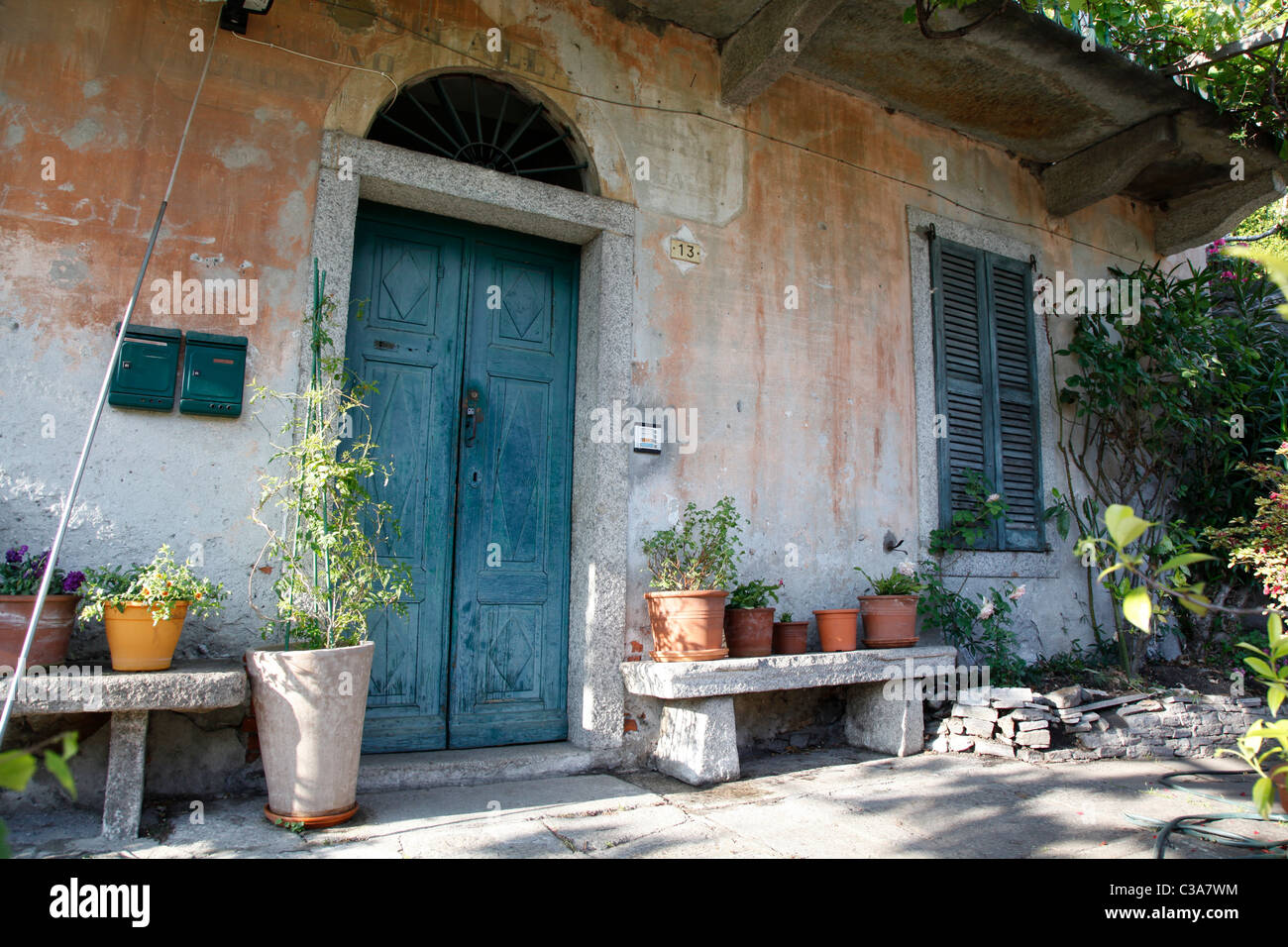 A small Italian courtyard and stone benches Stock Photo - Alamy
