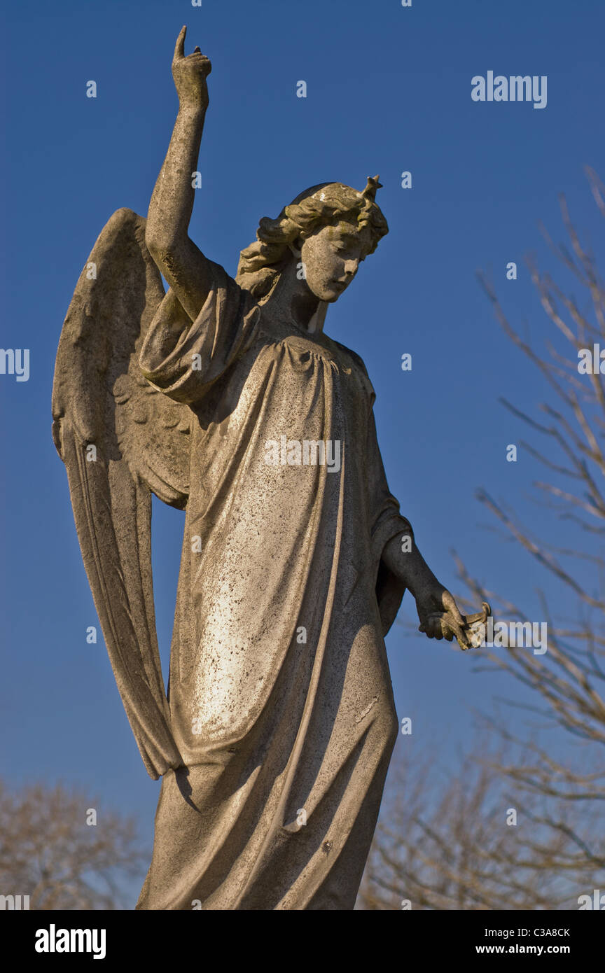A stone statue of an archangel against a blue sky Stock Photo - Alamy