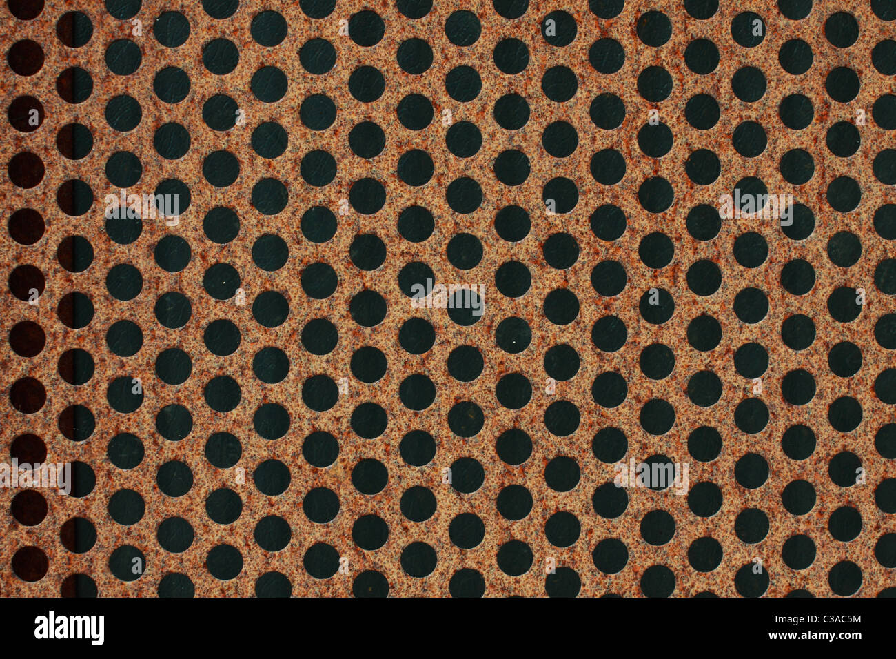 metal rusty texture with round holes in it Stock Photo - Alamy