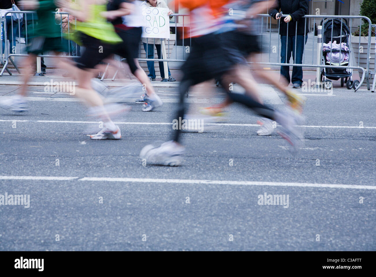 Spectator holding sign during race Stock Photo - Alamy