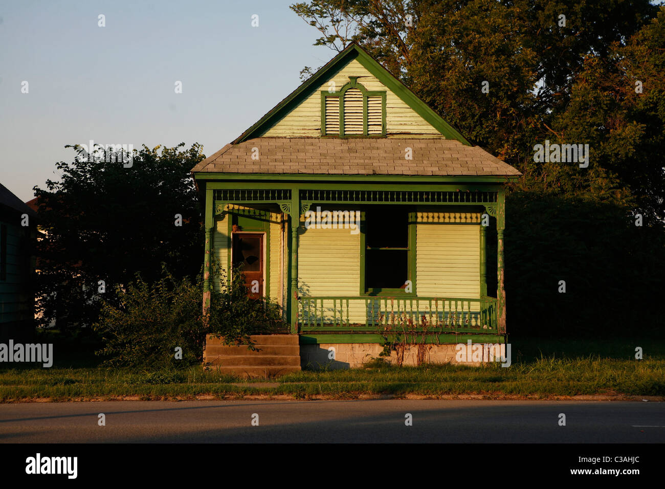 A green, empty, abandoned, run down house sits along a street in Cairo ...