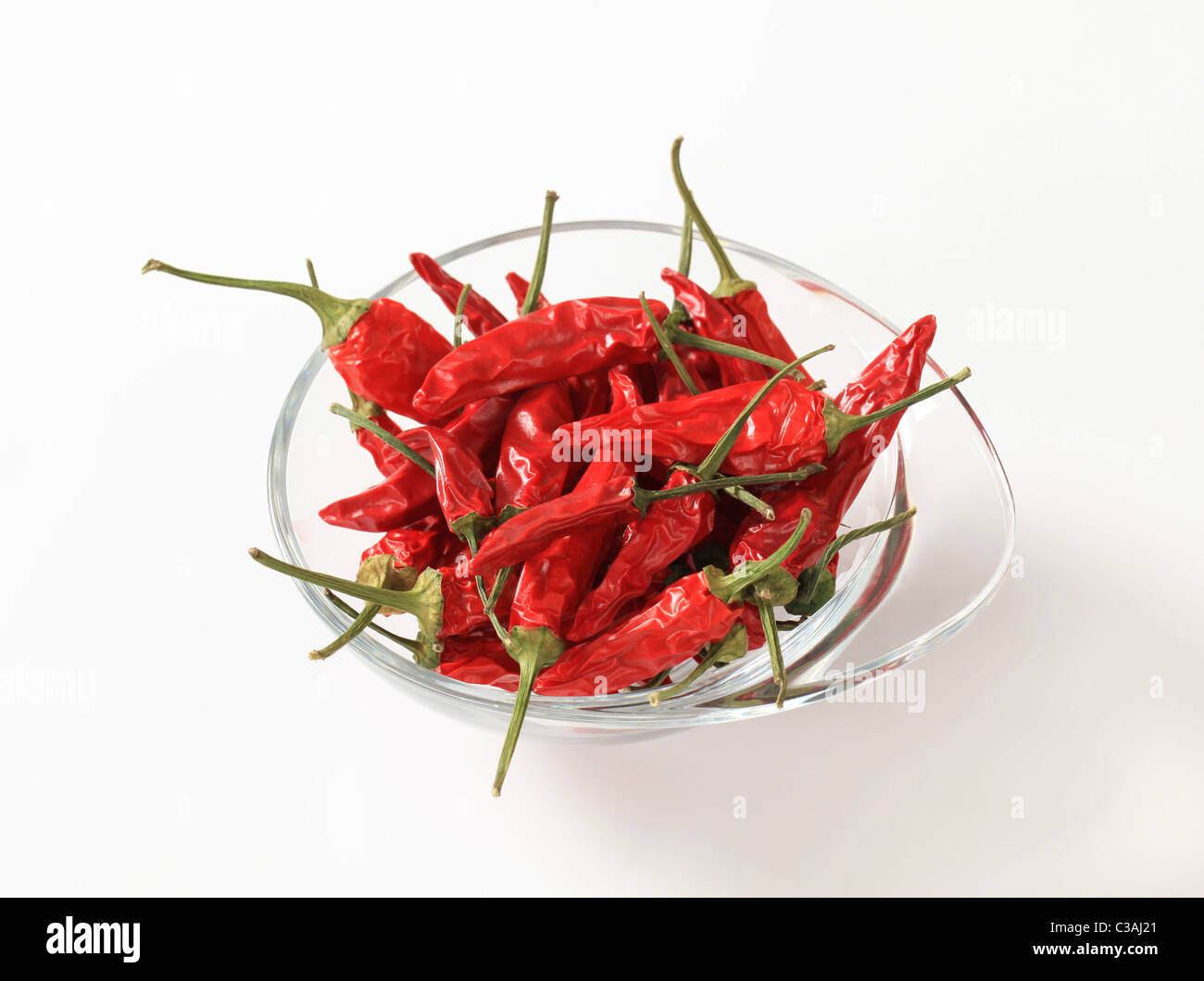 Dried red chili peppers in a glass bowl Stock Photo - Alamy