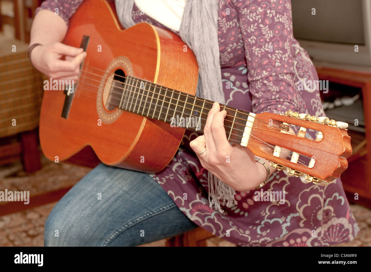 Lady playing the guitar Stock Photo - Alamy