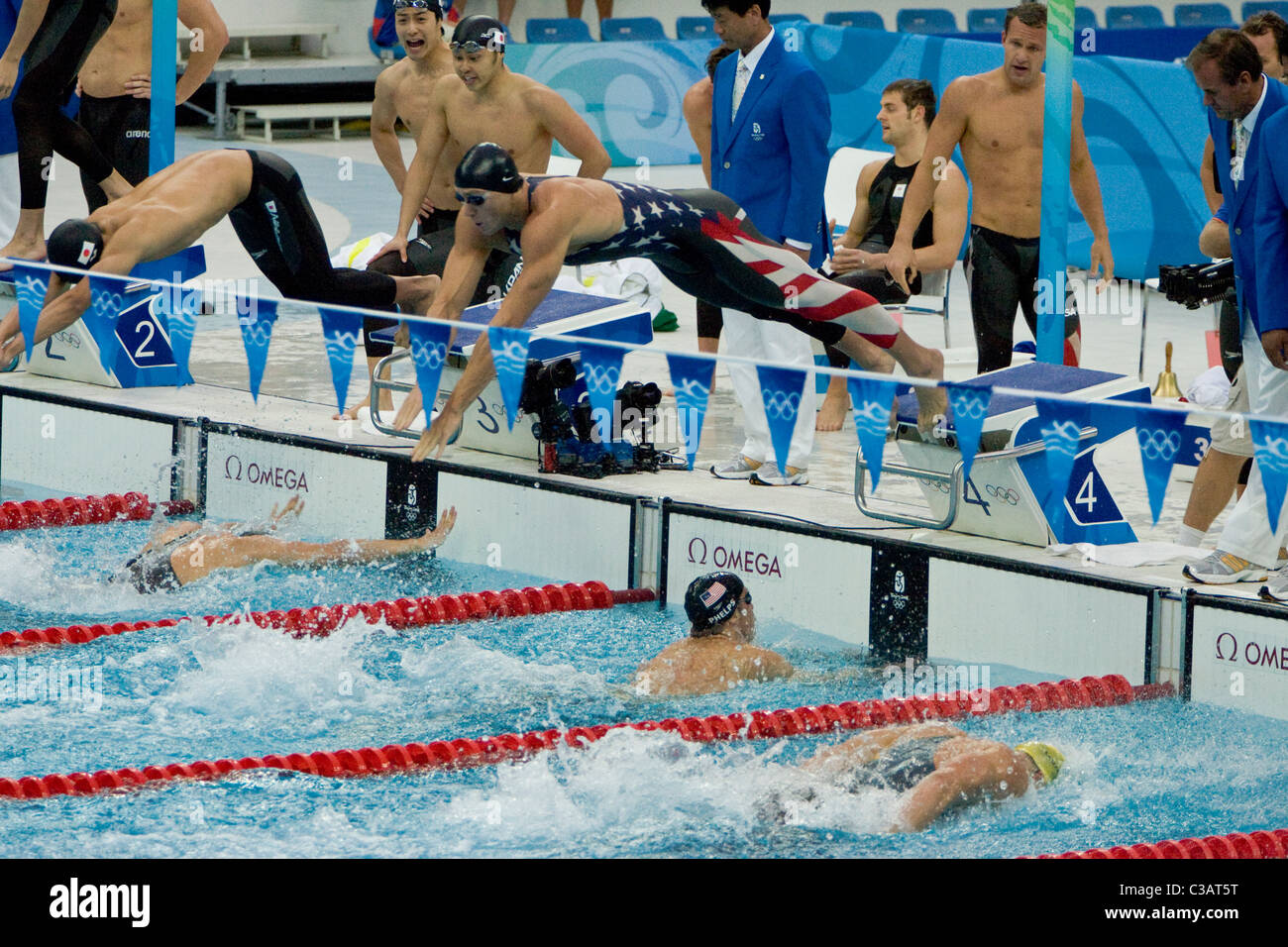 Michael Phelps finishing the butterfly leg while Jason Lezak starts the ...