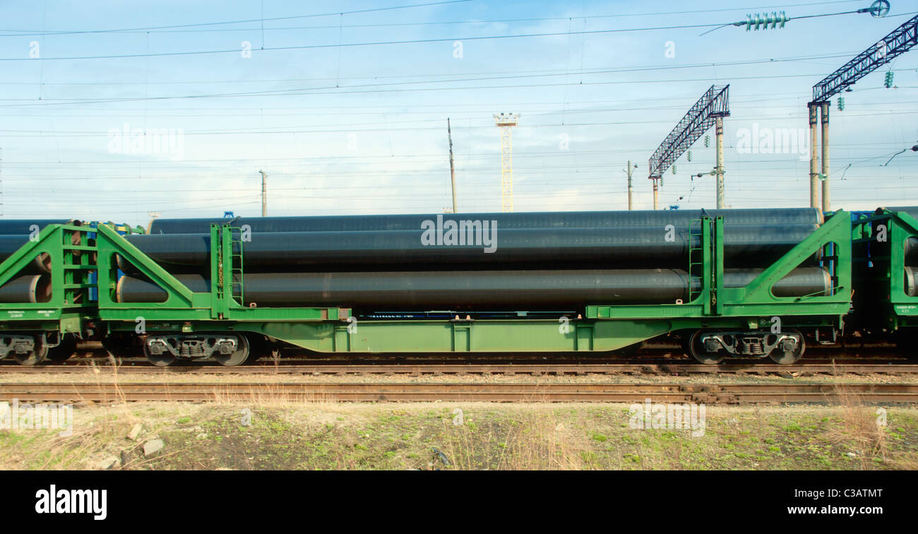 Railroad flatcars with pipes on railroad station Stock Photo - Alamy