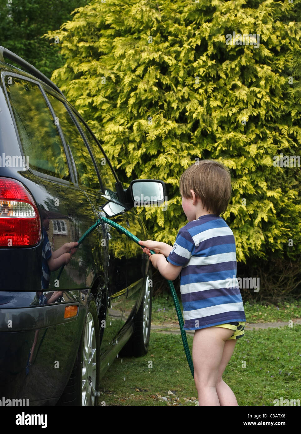 Boy washing car pipe hi-res stock photography and images - Alamy