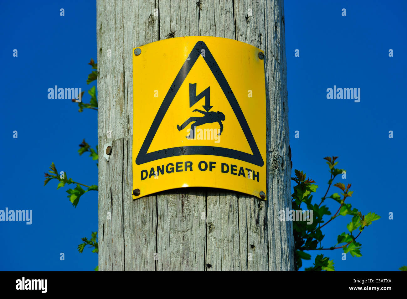 Warning sign on wooden pole hi-res stock photography and images - Alamy