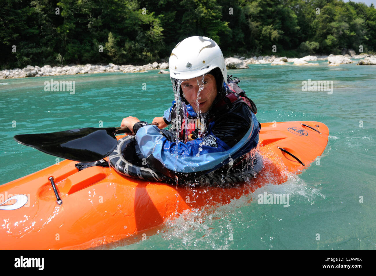Kayaker demonstrating eskimo turn on Soca river Stock Photo - Alamy