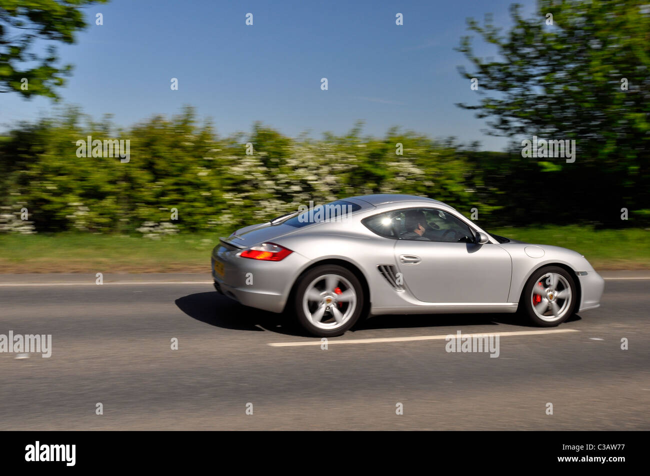 Porsche driven on road with motion blur Stock Photo - Alamy