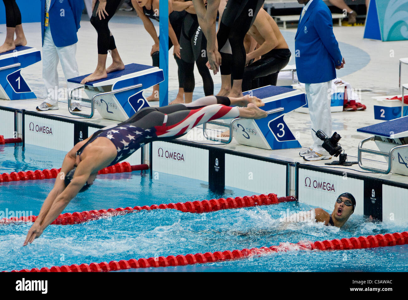 Ricky Berens touches the wall as Peter Vanderkaay start the fourth leg ...