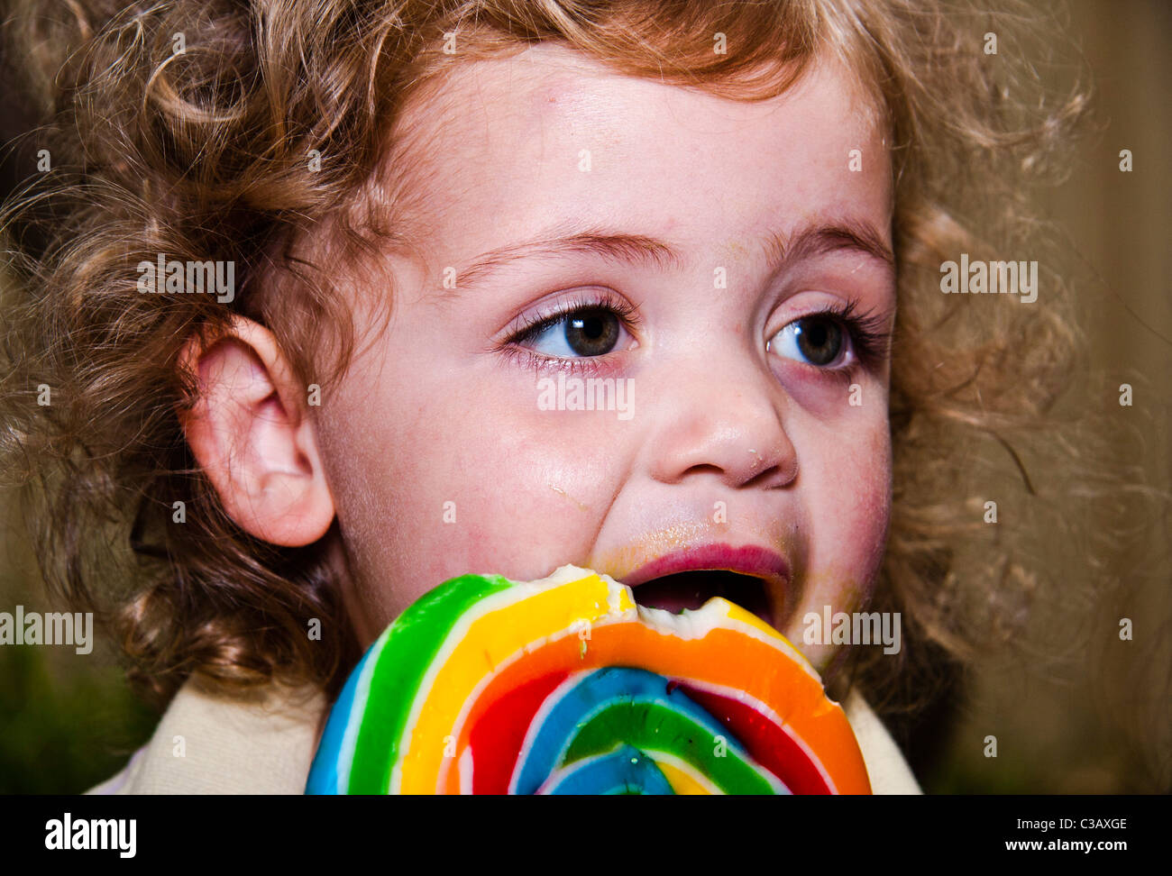 A young girl eats a candy lolly Stock Photo - Alamy
