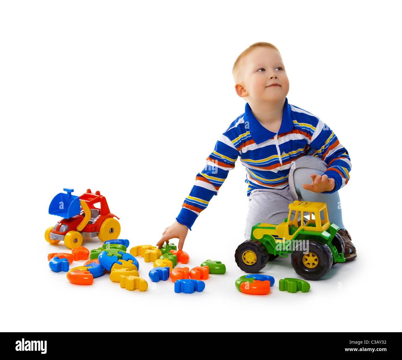Little boy playing with toys on the floor Stock Photo - Alamy