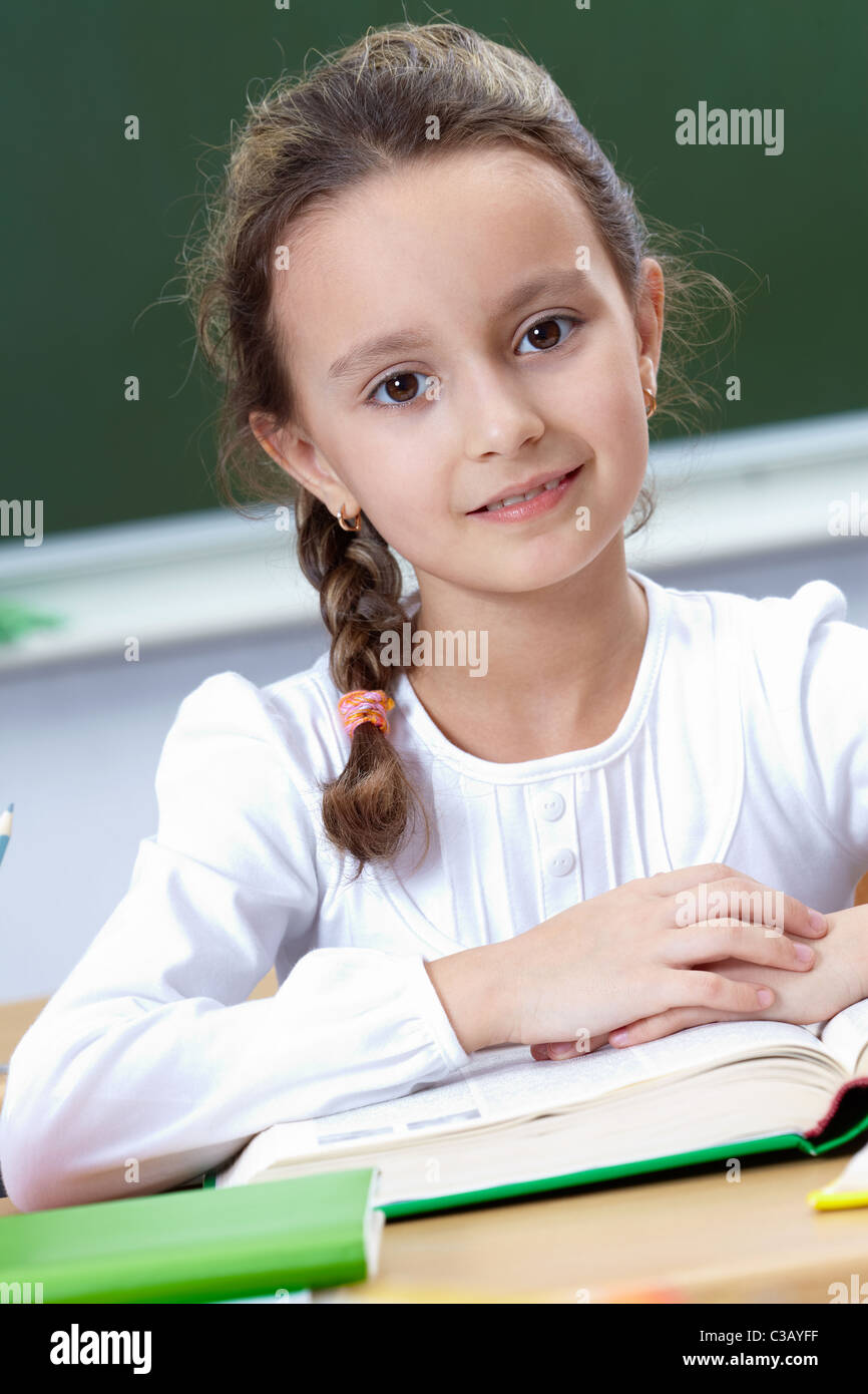 Portrait of pretty girl at workplace looking at camera Stock Photo - Alamy