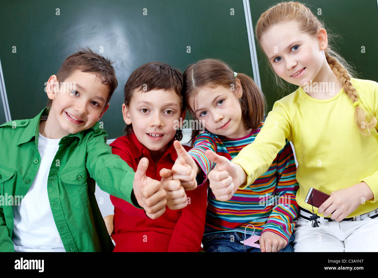 Group of four classmates showing sign of ok Stock Photo - Alamy