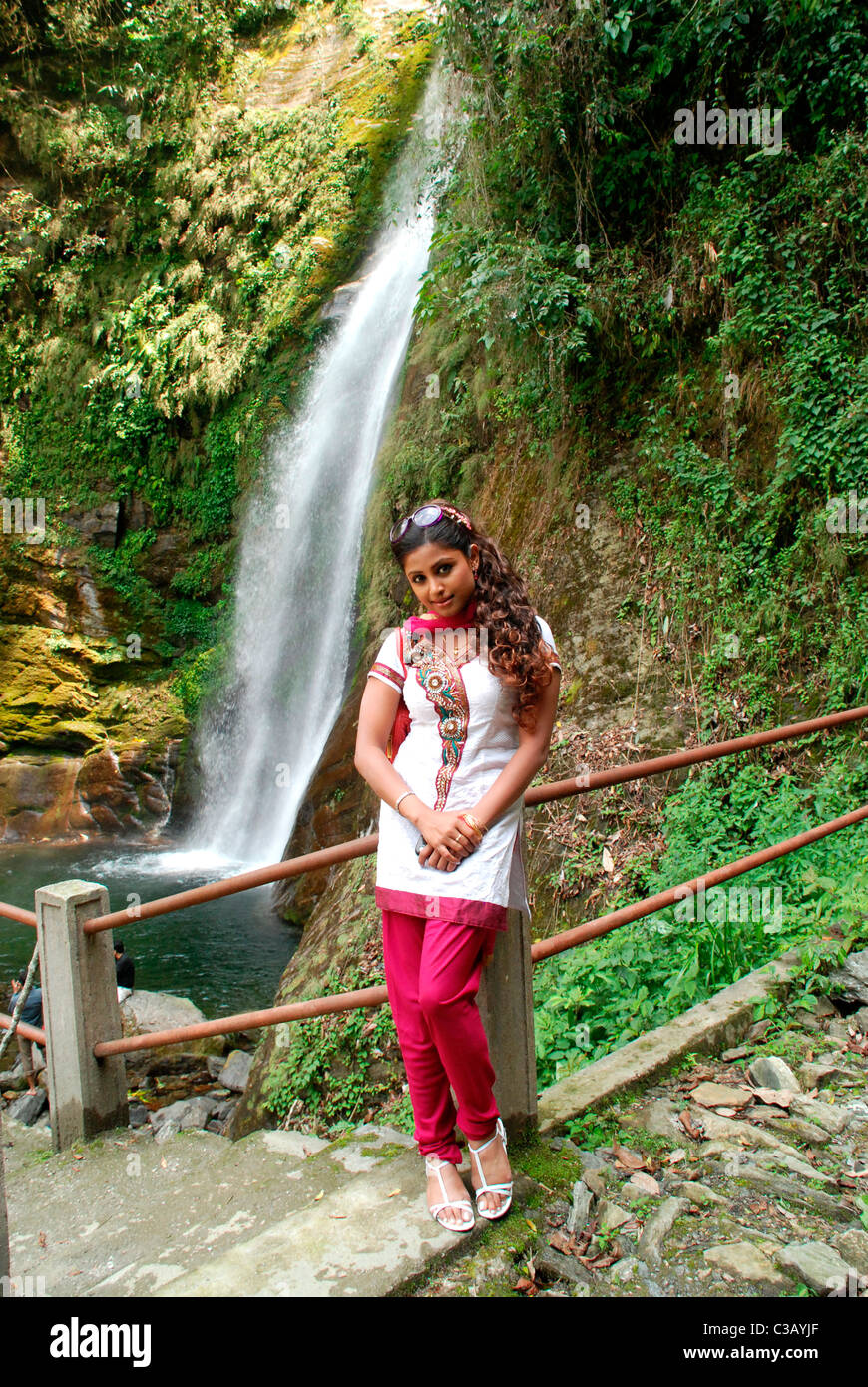 Indian girl leaning on railing near water fall Stock Photo - Alamy
