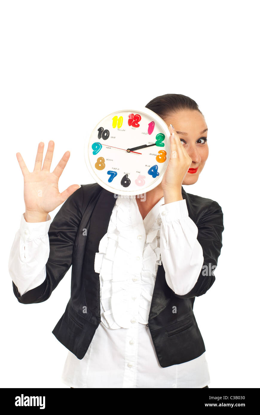 Happy business woman standing behind a clock and showing five fingers ...