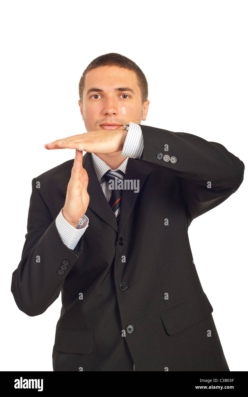 Serious business man gesturing time out isolated on white background ...