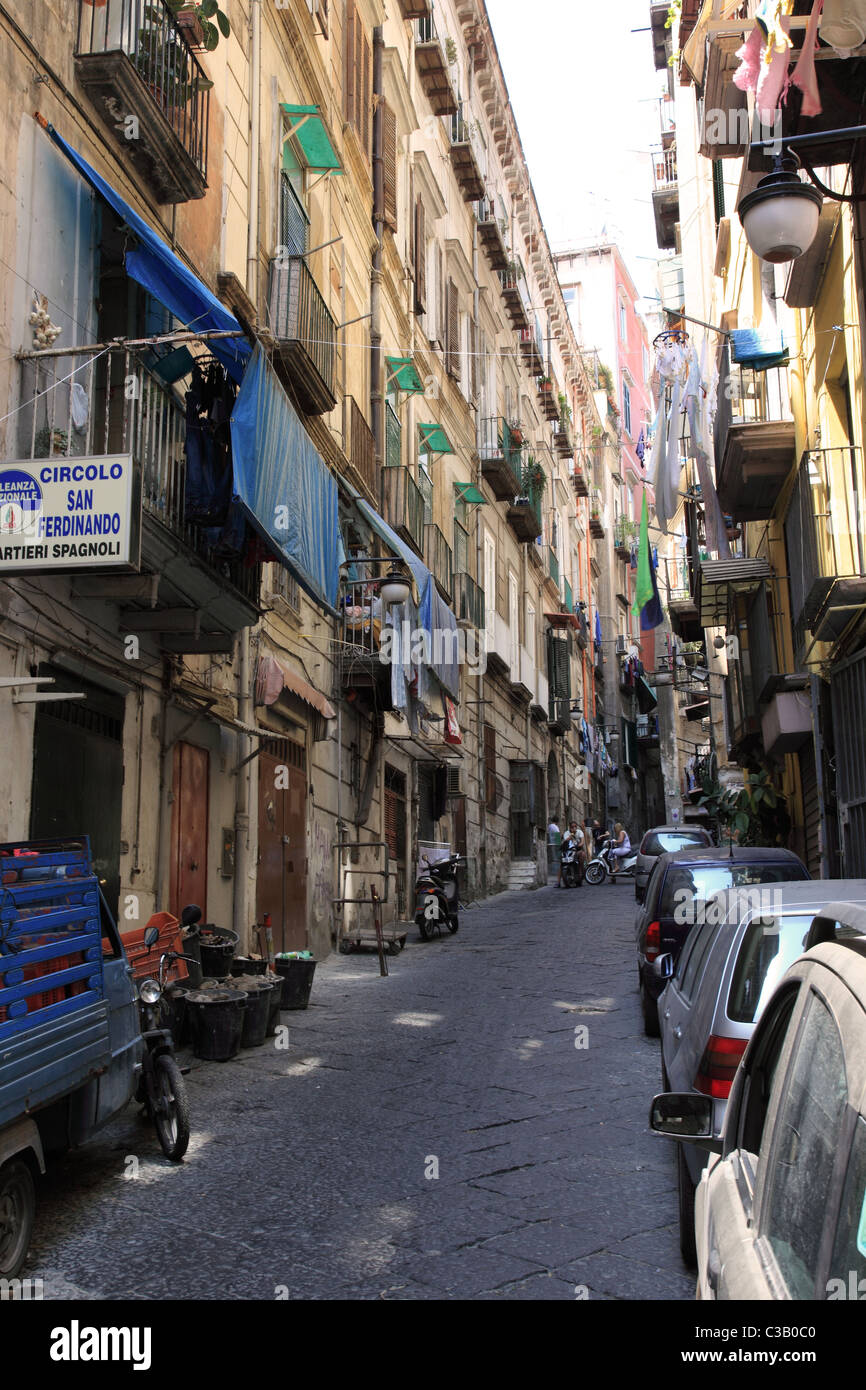 A narrow street in Naples with washing hanging out to dry and lined ...