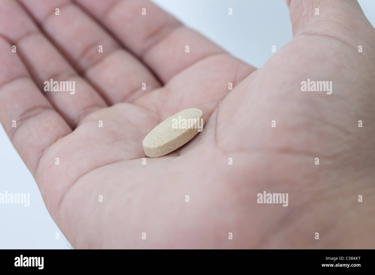 Pill in a hand Stock Photo - Alamy