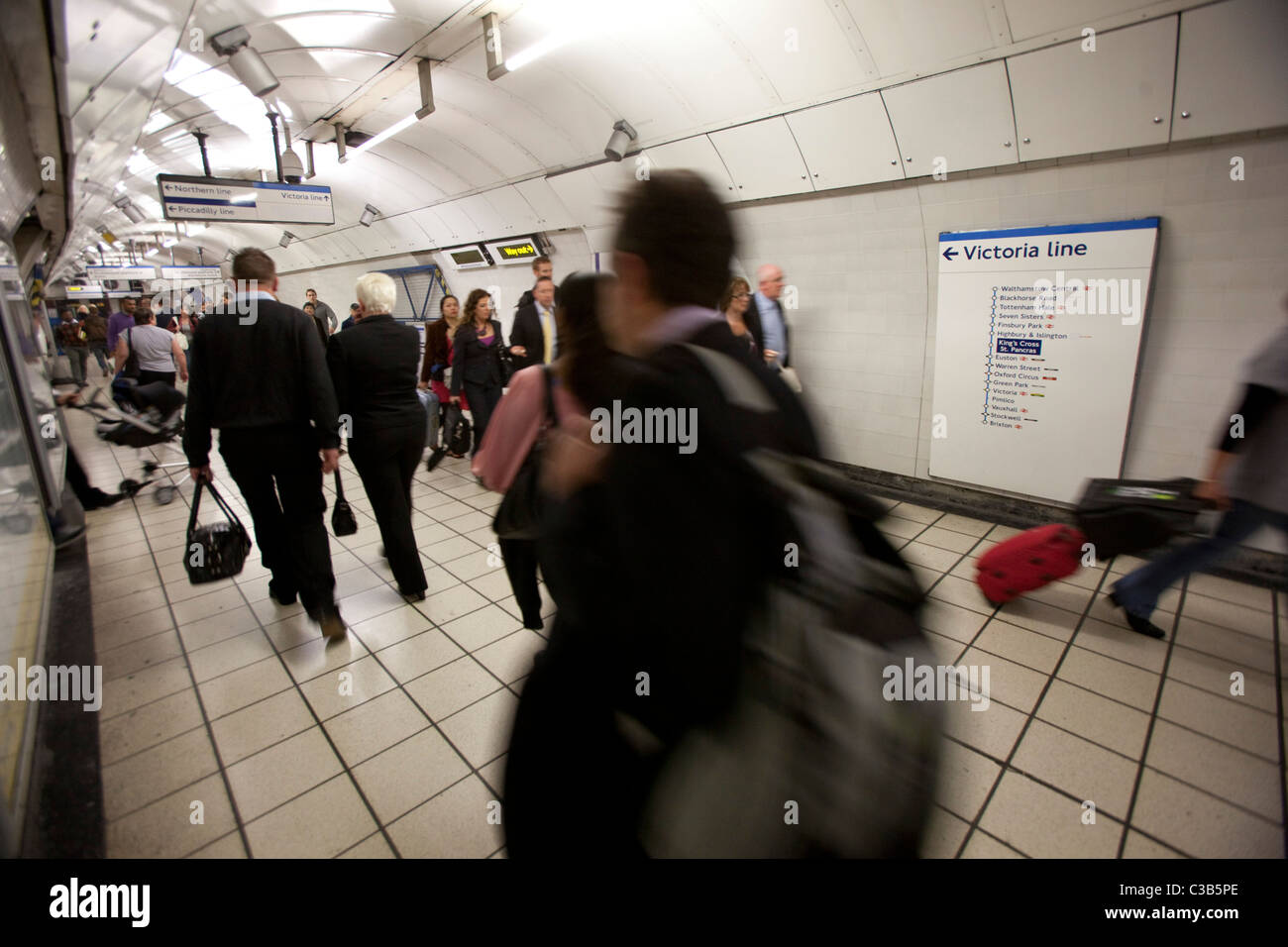 Commuters and tourists make their way to the Victoria line platforms at ...