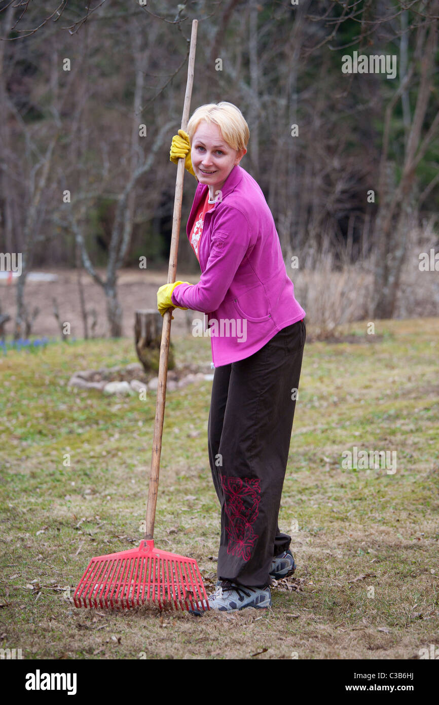 Caucasian Woman Raking Leaves Stock Photo - Alamy