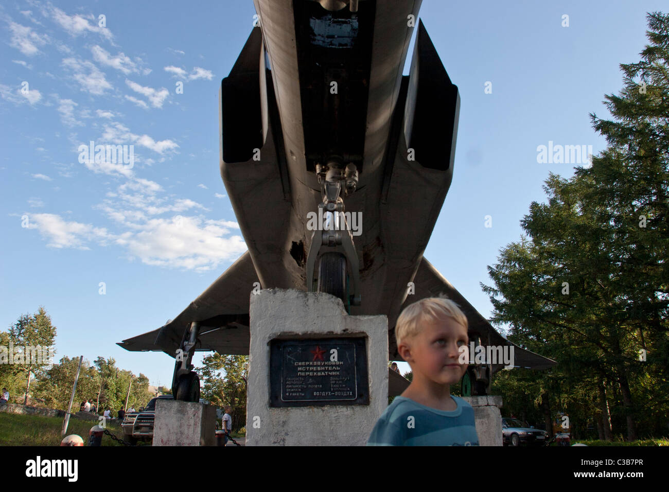 Children play near a memorial of a Soviet era fighter jet in Yuzhno ...