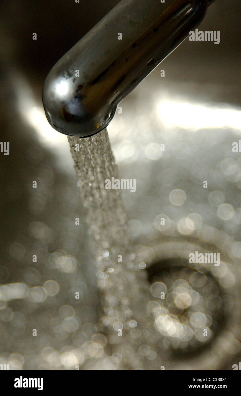 A tap with running water Stock Photo - Alamy